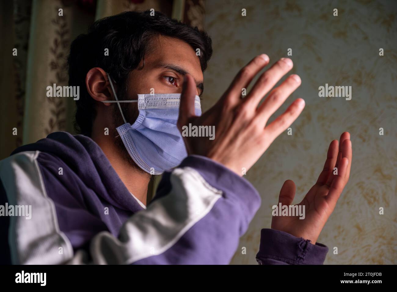 Male wearing mask and praying for allah to protect him from diseases ...