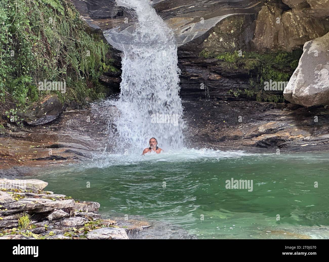Man bathing at the Santa Petronilla waterfall , Biasca, Switzerland ...