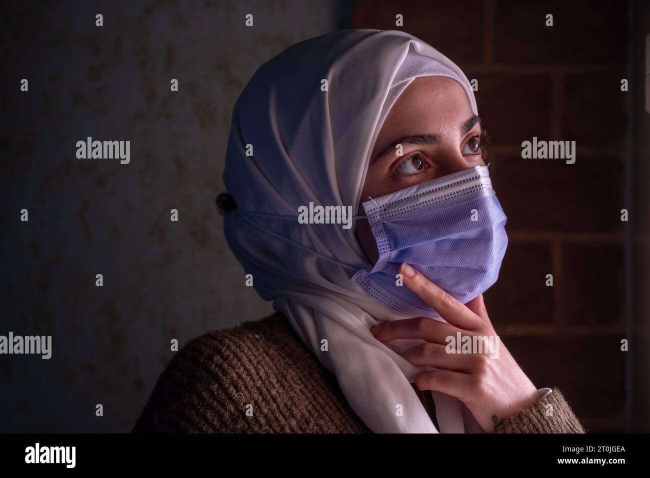 Muslim woman wearing mask and praying for allah to protect her from ...