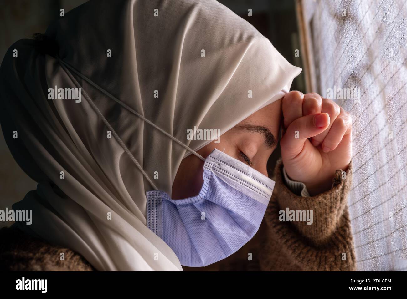 Muslim woman wearing mask and praying for allah to protect her from ...
