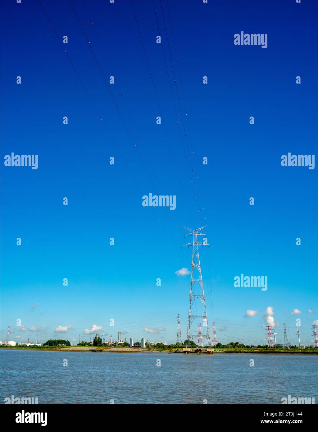 Power cables and pylons on the waterside of river Schelde in Antwerp ...