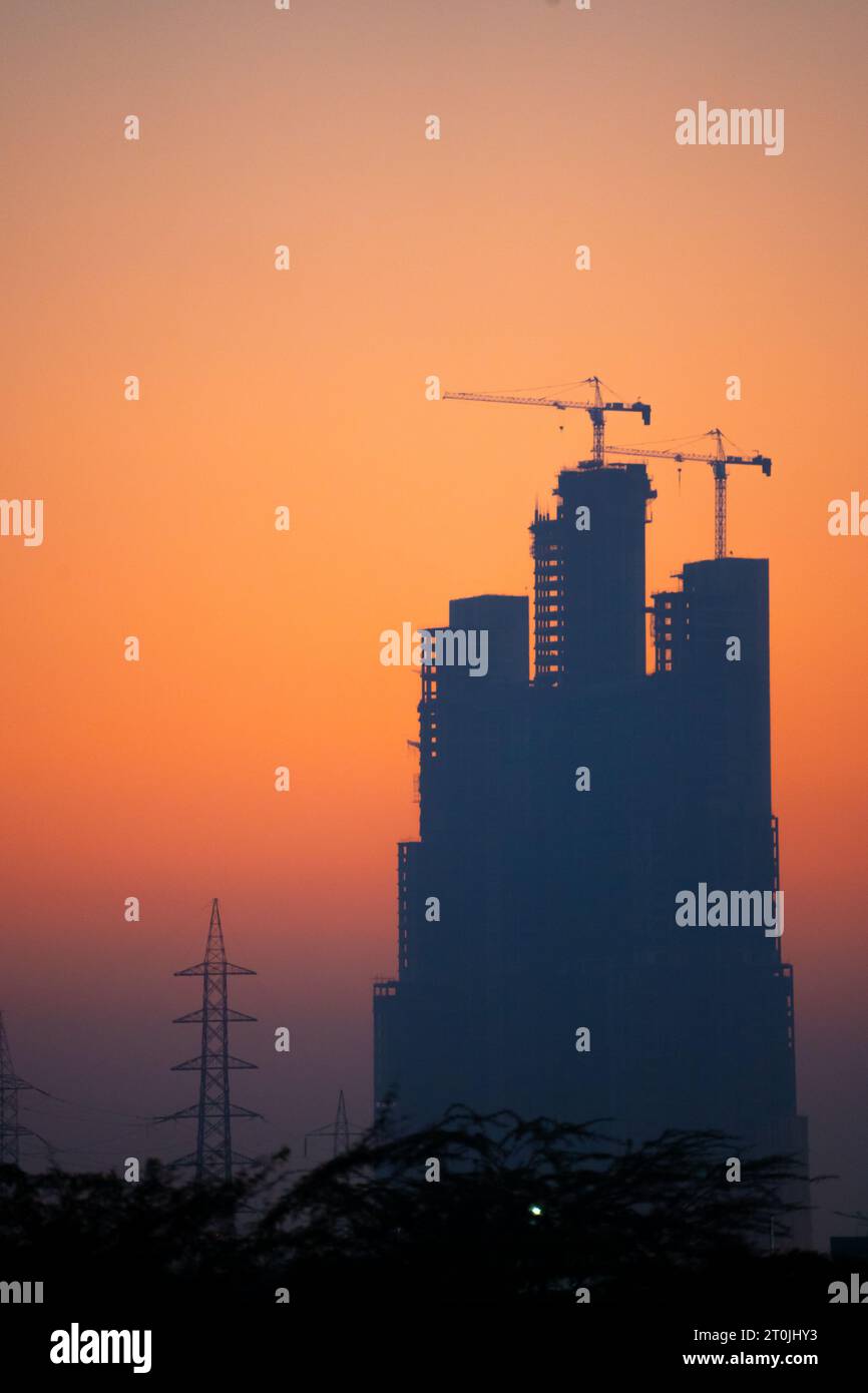 Evening dusk twilight shot showing under construction skyscraper multi ...