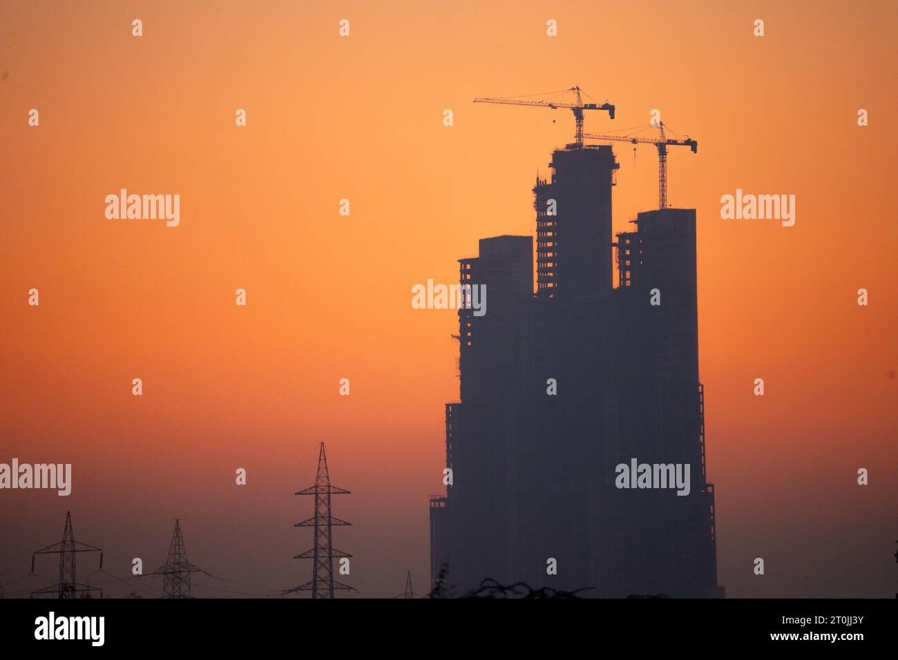 Evening dusk twilight shot showing under construction skyscraper multi ...