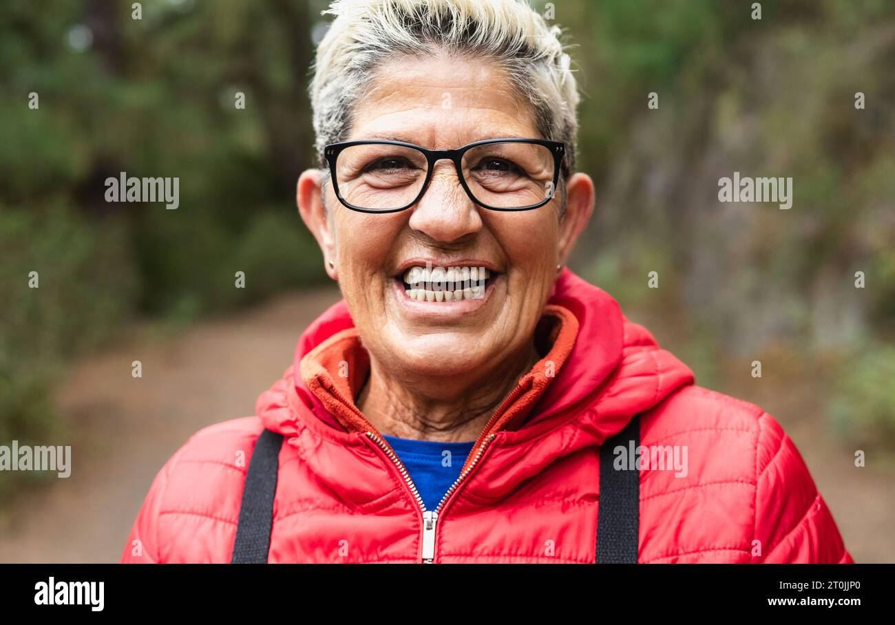 Happy senior woman having fun during trekking activities day in the ...