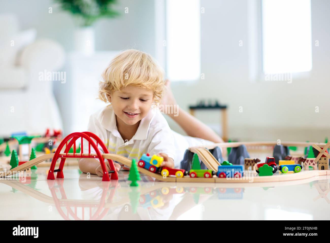 Kids play with wooden railway. Child with toy train. Educational toys ...