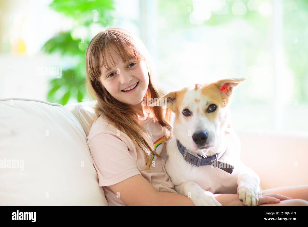 Child playing with big dog. Girl cuddling shepherd puppy. Kids and ...