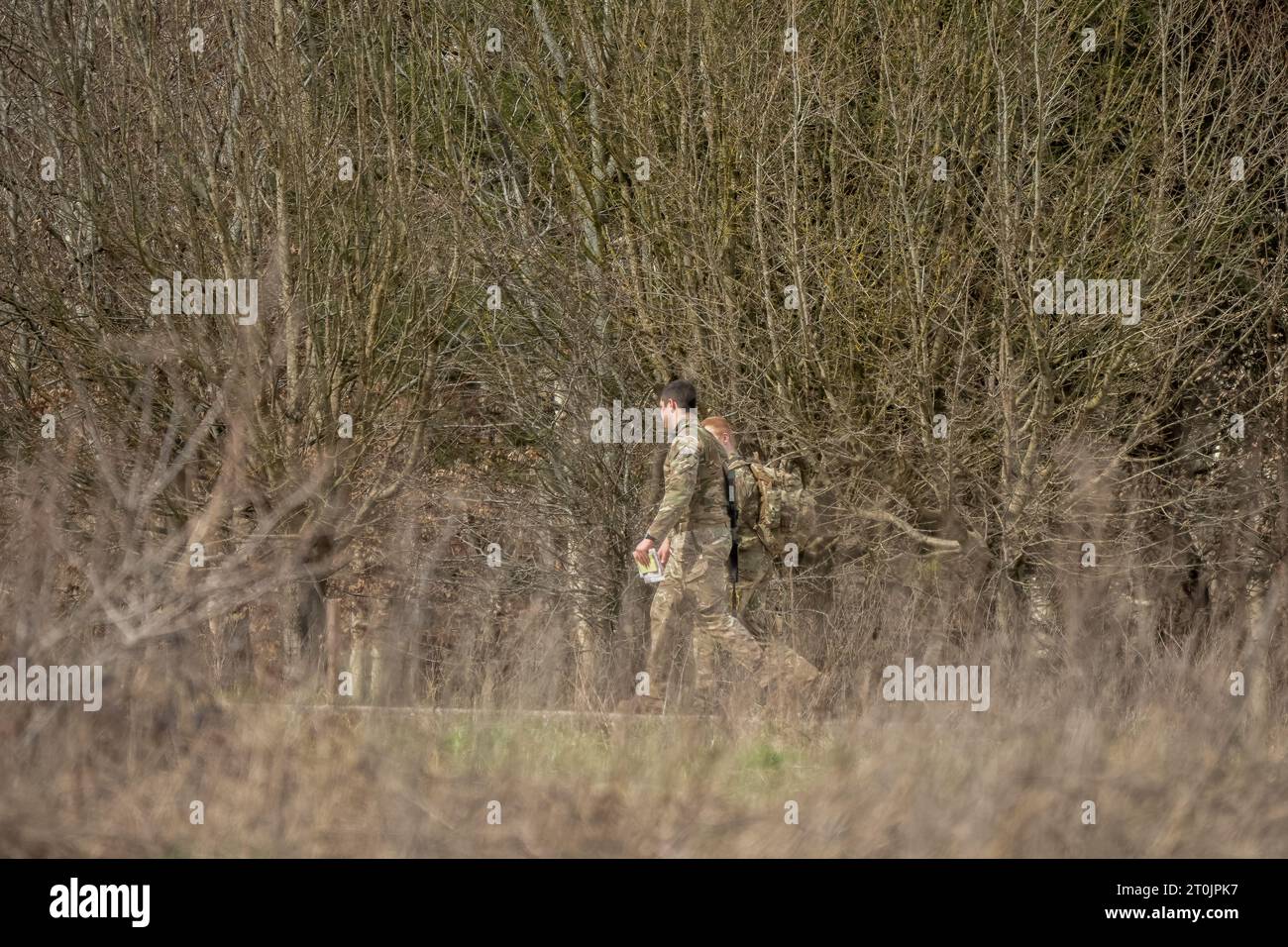British army infantry soldiers walking along a track by woodlands Stock ...