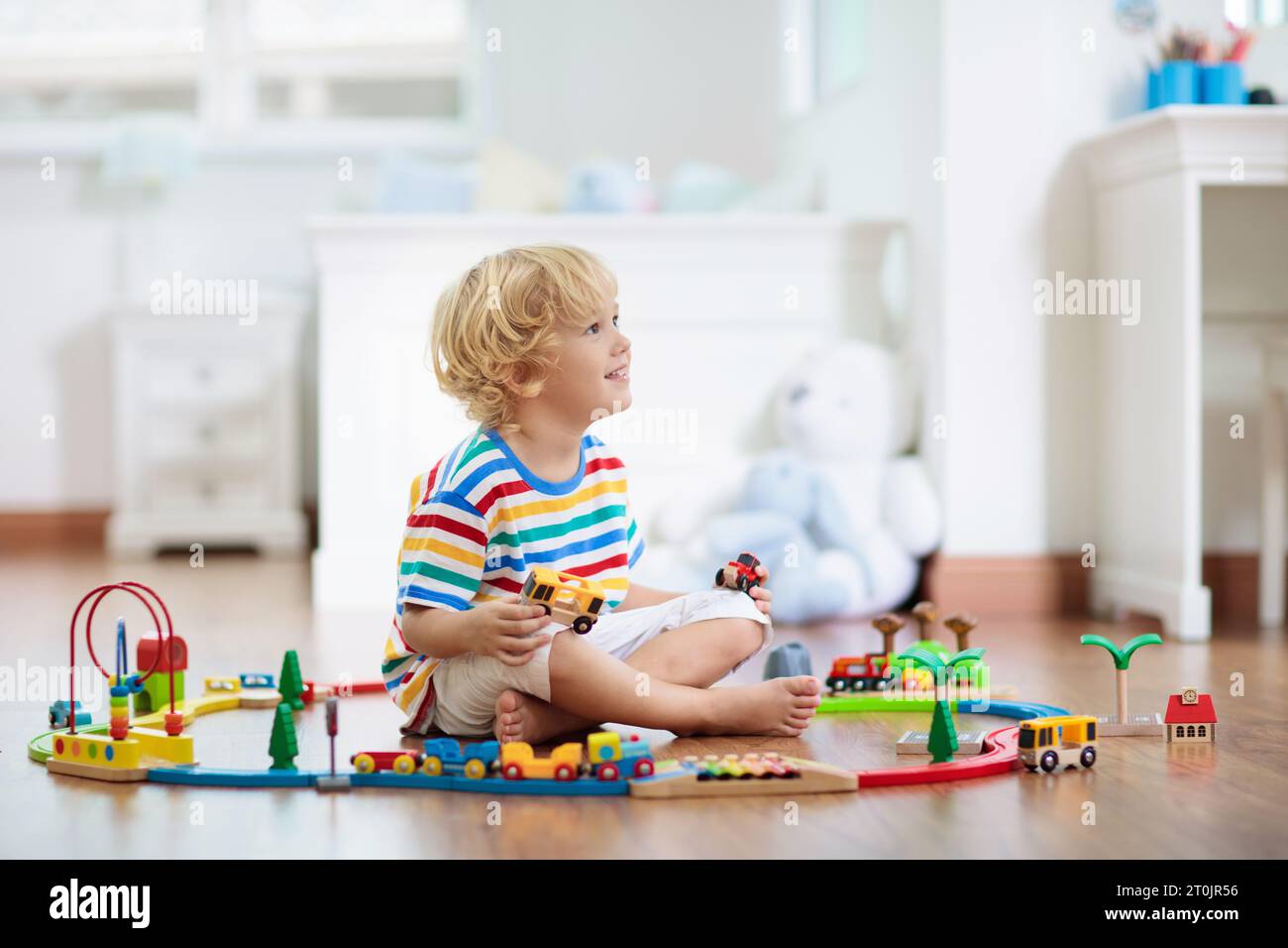 Kids play with wooden railway. Child with toy train. Educational toys ...