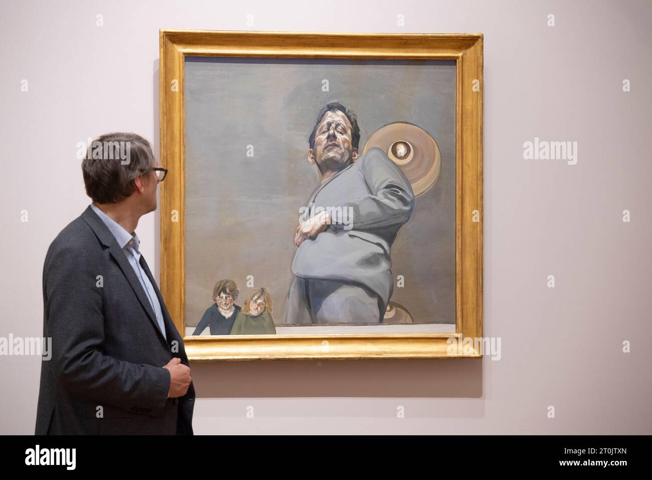 A member of the gallery staff looking at the Lucian Freud painting ...