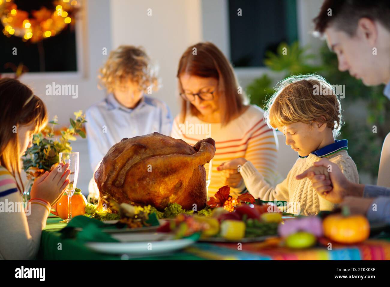 Family at Thanksgiving dinner. Parents, grandparents and kids enjoy ...