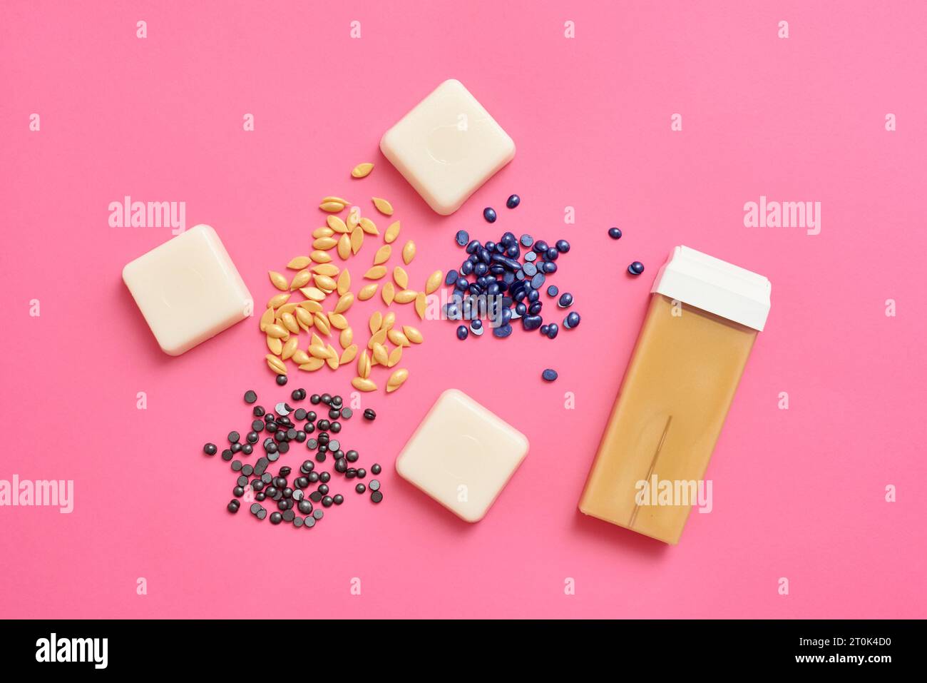 Different types of wax for depilation top view on a pink background ...