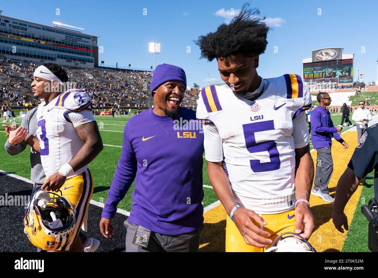 LSU quarterback Jayden Daniels, right, walks off the field after ...
