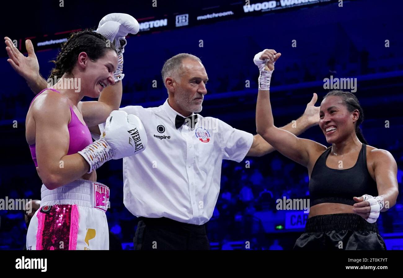 Terri Harper and Cecilia Braekhuslift lift their arms following the result of a tie in their WBA ...