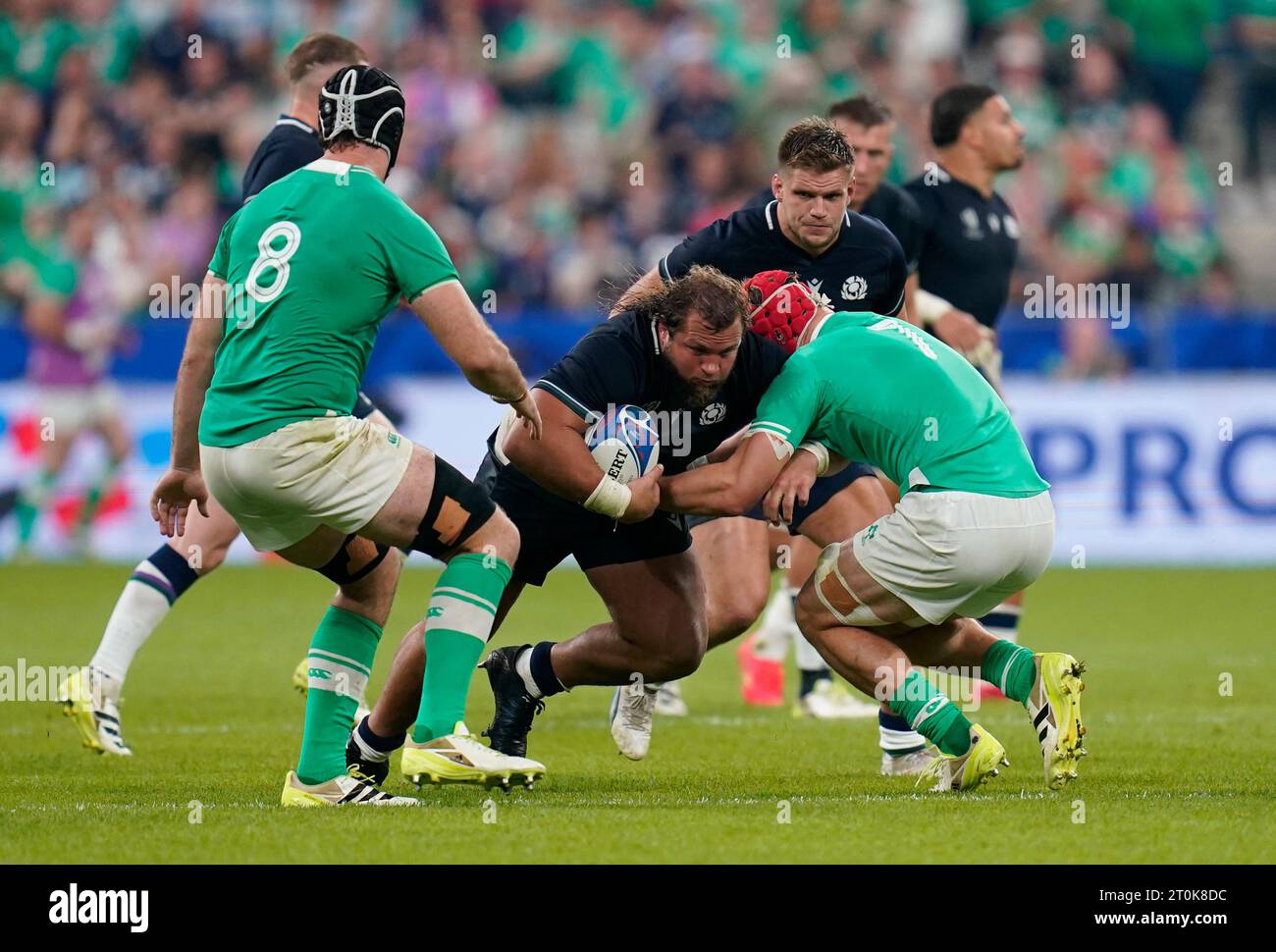 Scotland's Pierre Schoeman (centre) is tackled by Ireland's Josh van ...