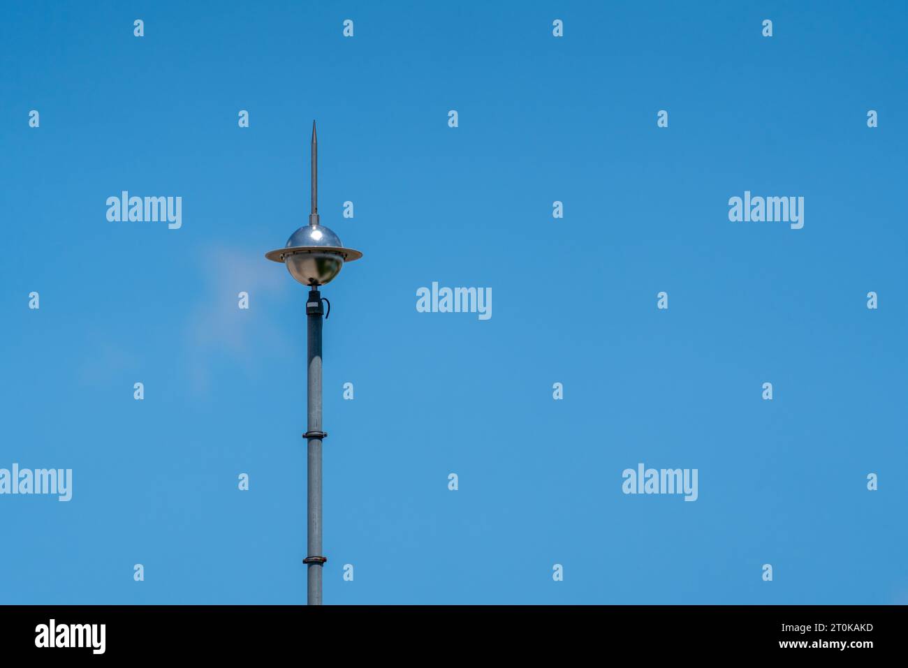Lightning rod on the roof of a building against a blue sky. Lightning ...