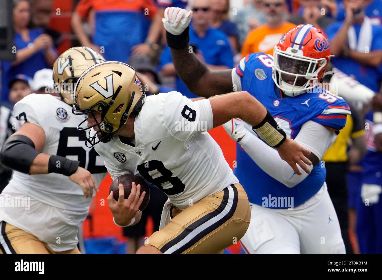 Vanderbilt quarterback Ken Seals (8) scrambles for yardage past Florida ...