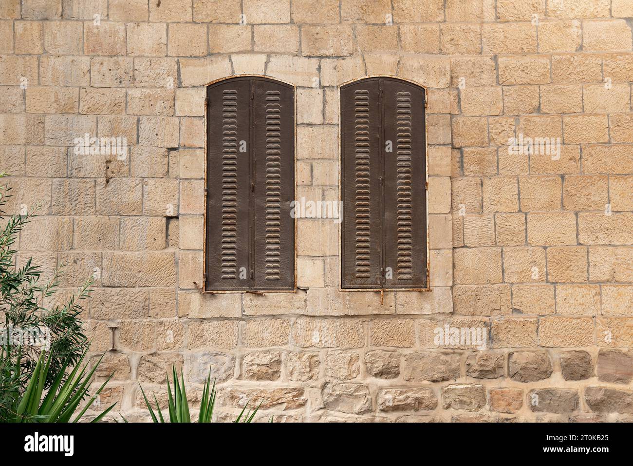 Background with shuttered windows on the wall of ancient israeli house ...