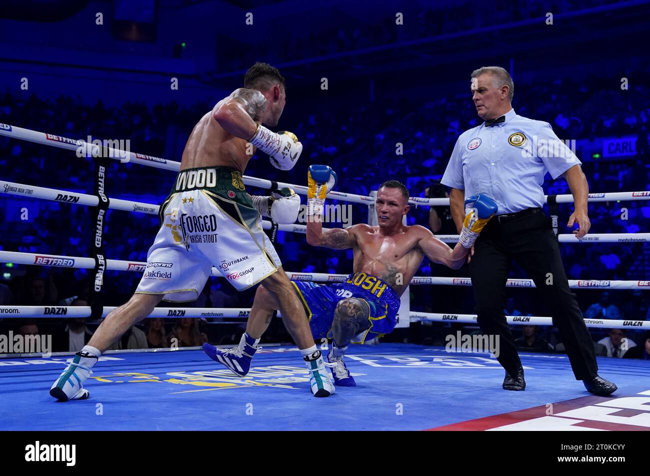 Leigh Wood (left) knocks down Josh Warrington to claim victory by TKO in their WBA Featherweight ...