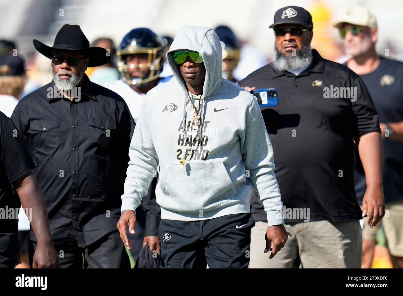 Colorado head coach Deion Sanders, center, walks on the field prior to ...
