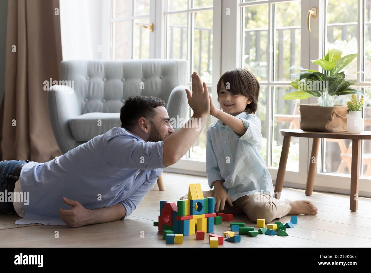 Happy father and little son boy playing constructing game Stock Photo ...