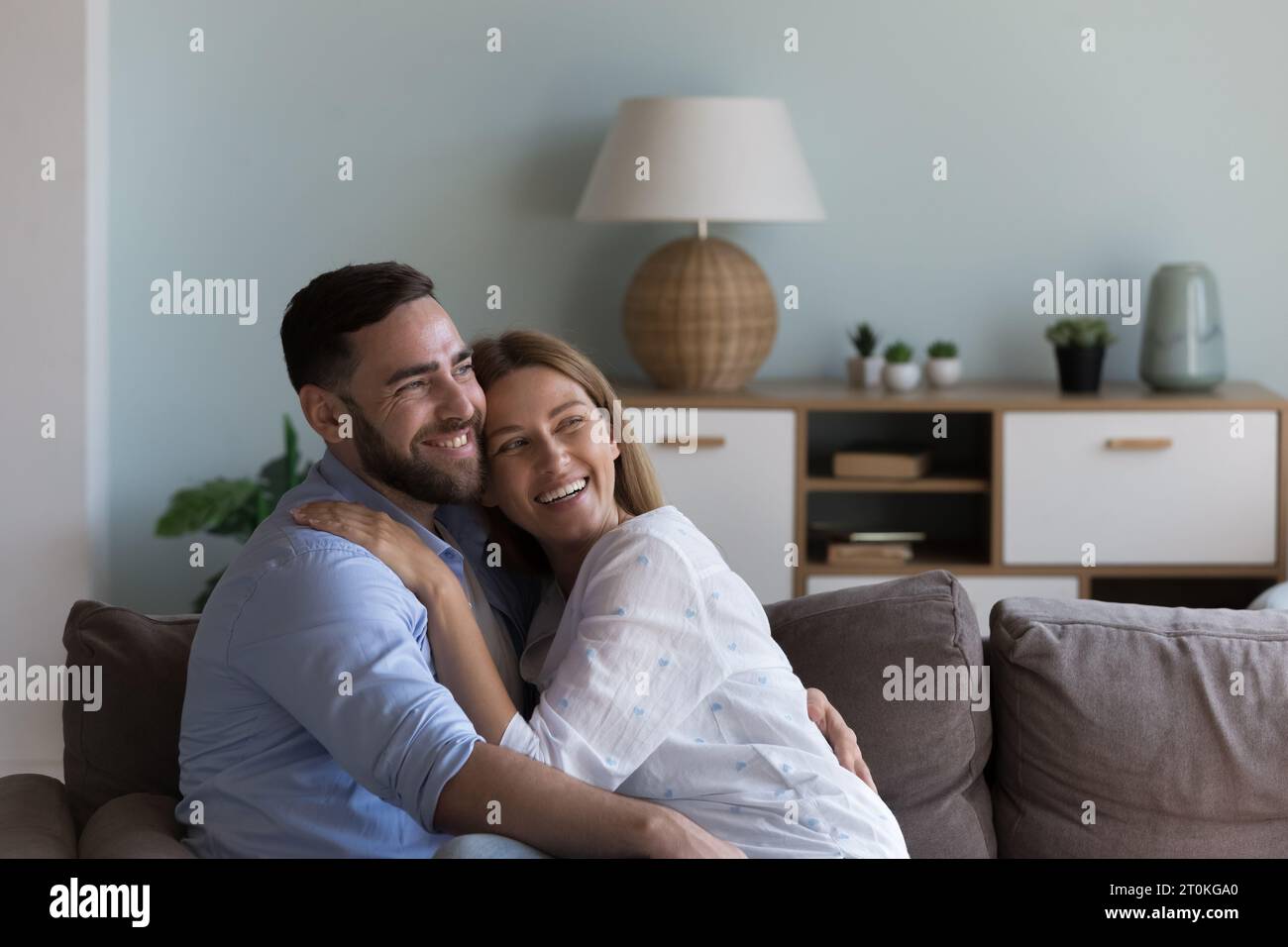Happy attractive married couple hugging at home with love Stock Photo ...