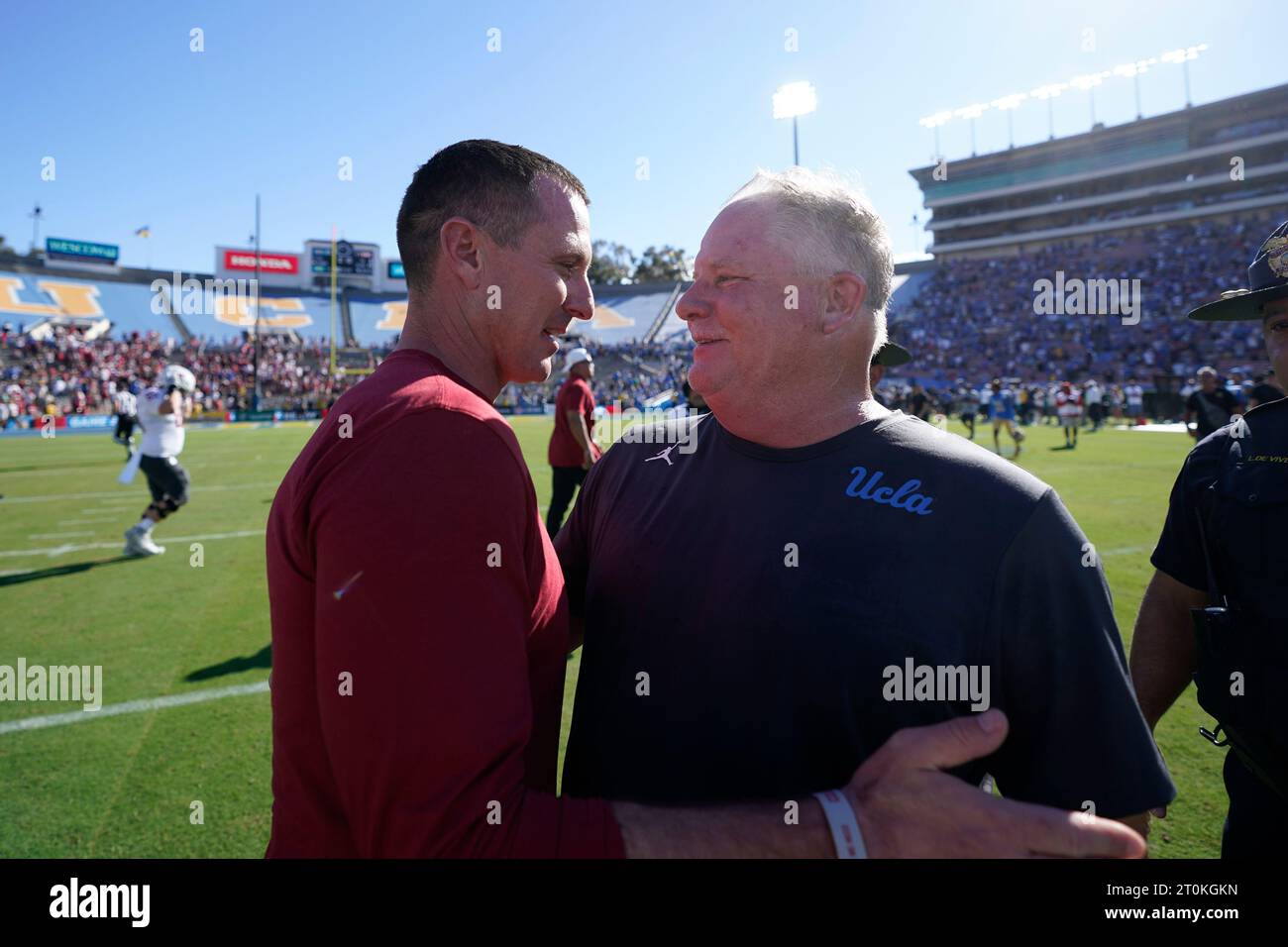 Washington State head coach Jake Dickert, left, greets UCLA head coach ...