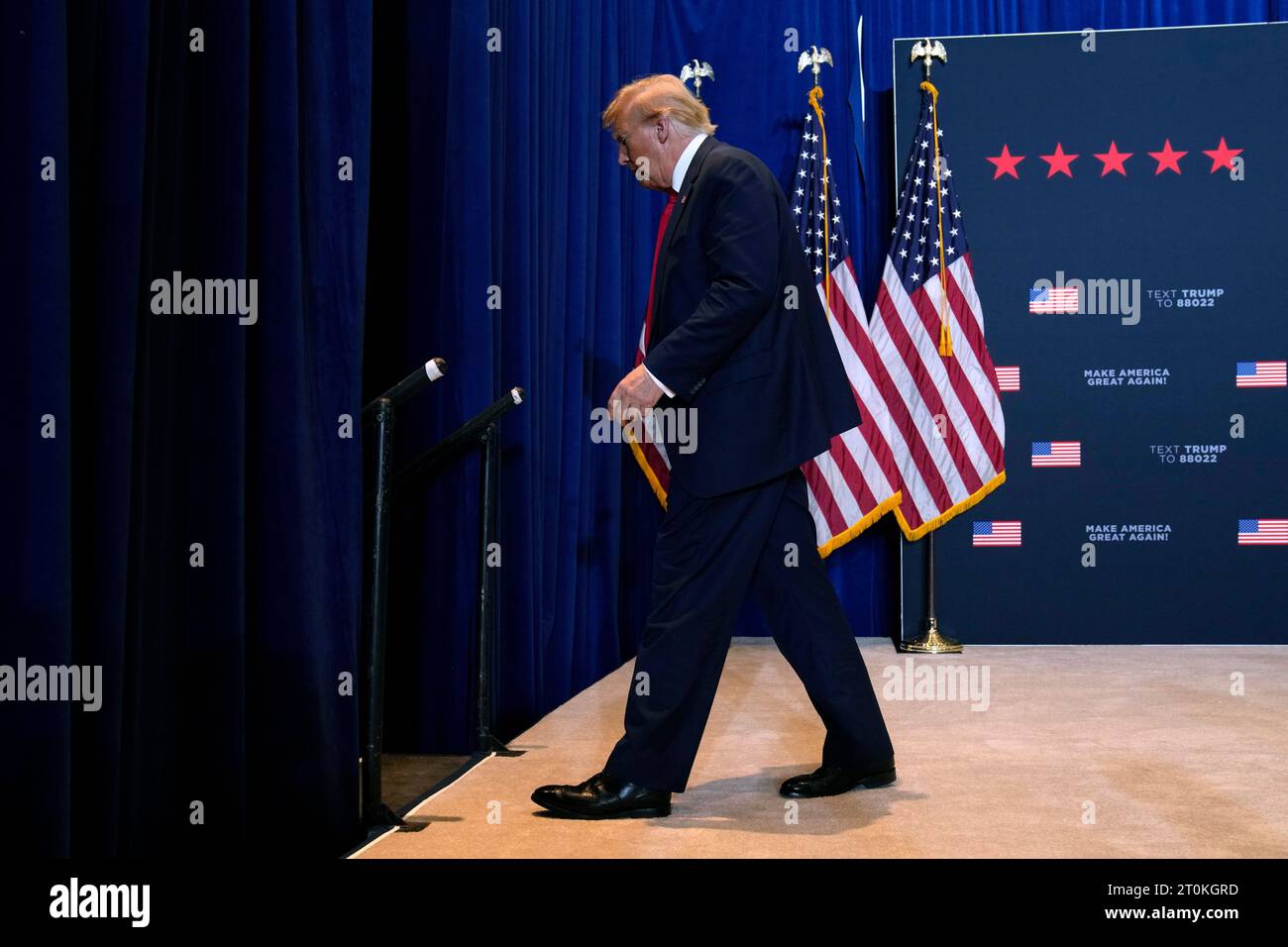 Former President Donald Trump walks off stage after a commit to caucus ...