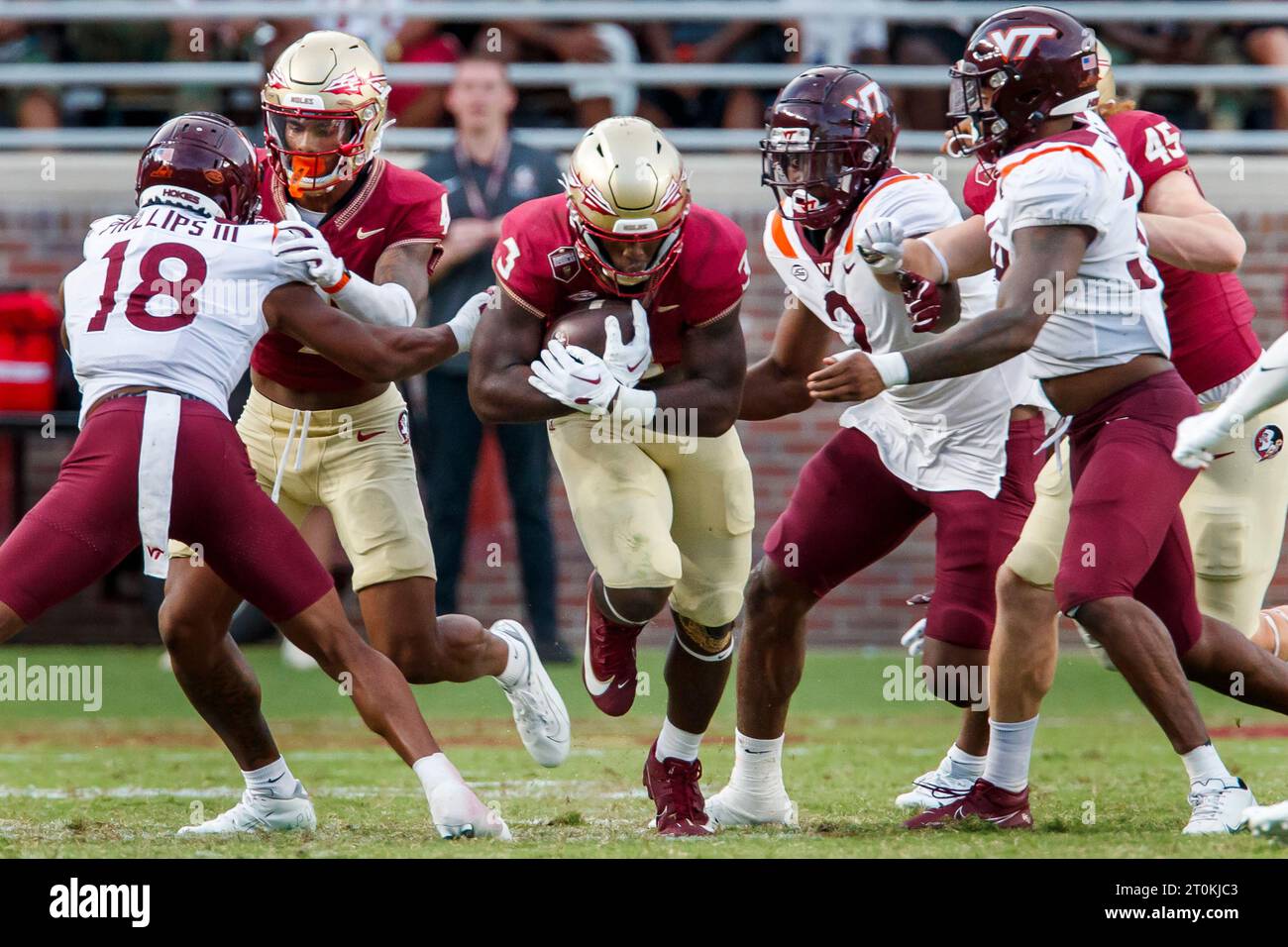 Florida State running back Trey Benson (3) breaks through the Virginia Tech line on a run during ...