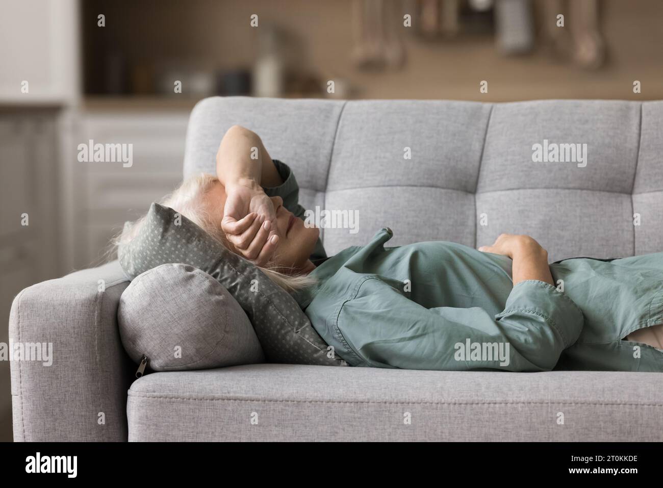 Woman napping mature sofa hi-res stock photography and images - Alamy