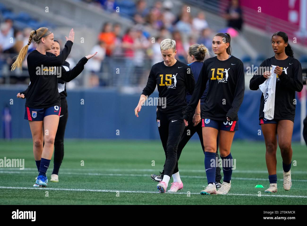 OL Reign forward Bethany Balcer, left, claps as forward Megan Rapinoe ...