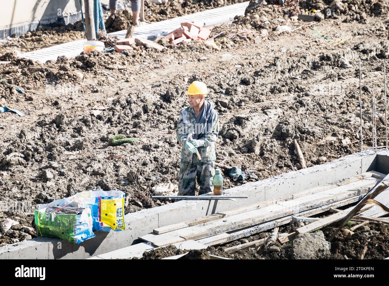 On a sunny day, construction workers are taking a break next to the ...