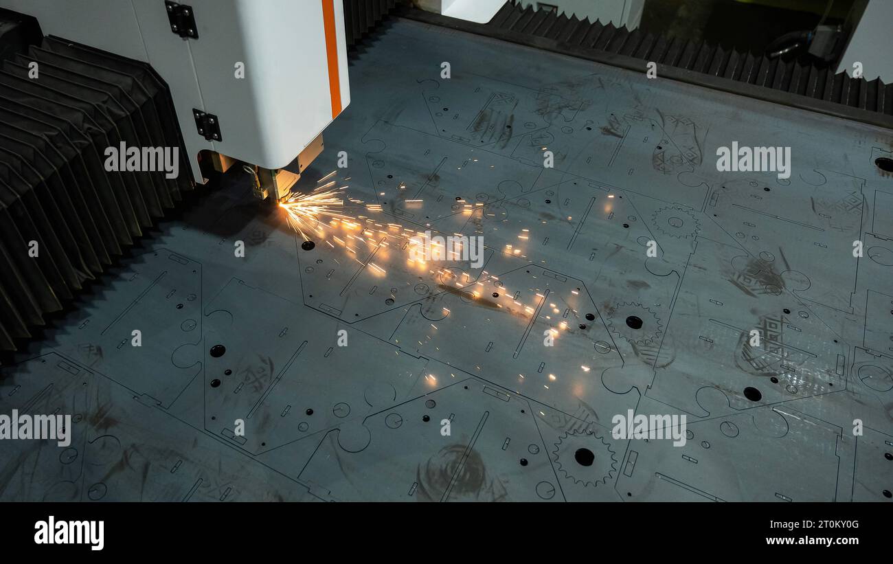 CNC machine. Laser cutting of metal. Sparks Stock Photo - Alamy