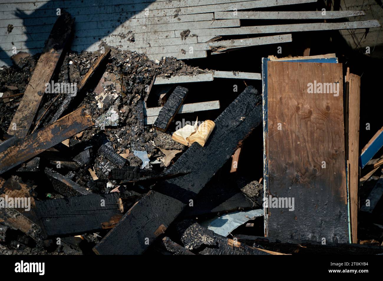 A burnt-out old wooden building after a fire. Charred beams after the ...