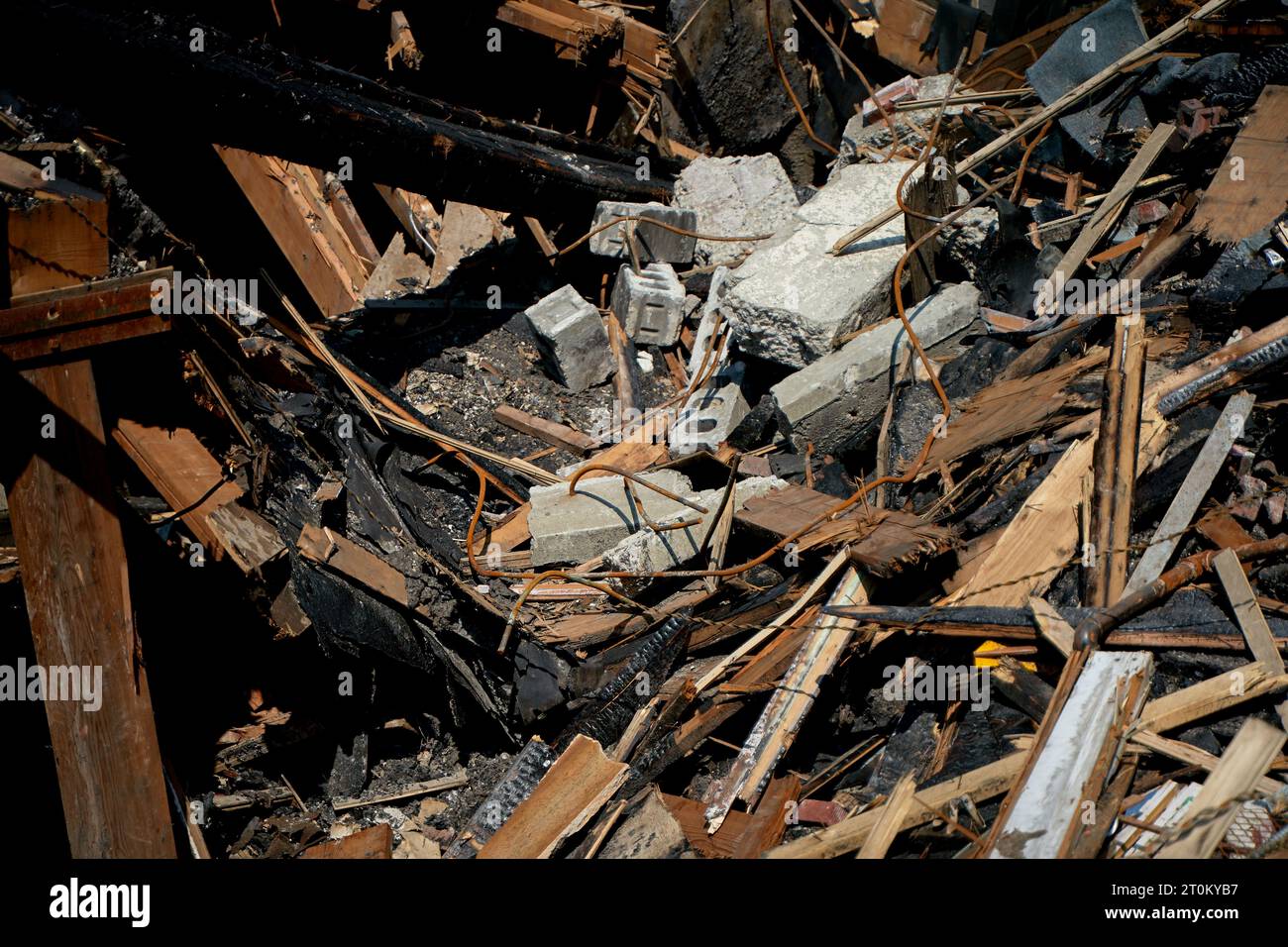 A burnt-out old wooden building after a fire. Charred beams after the ...
