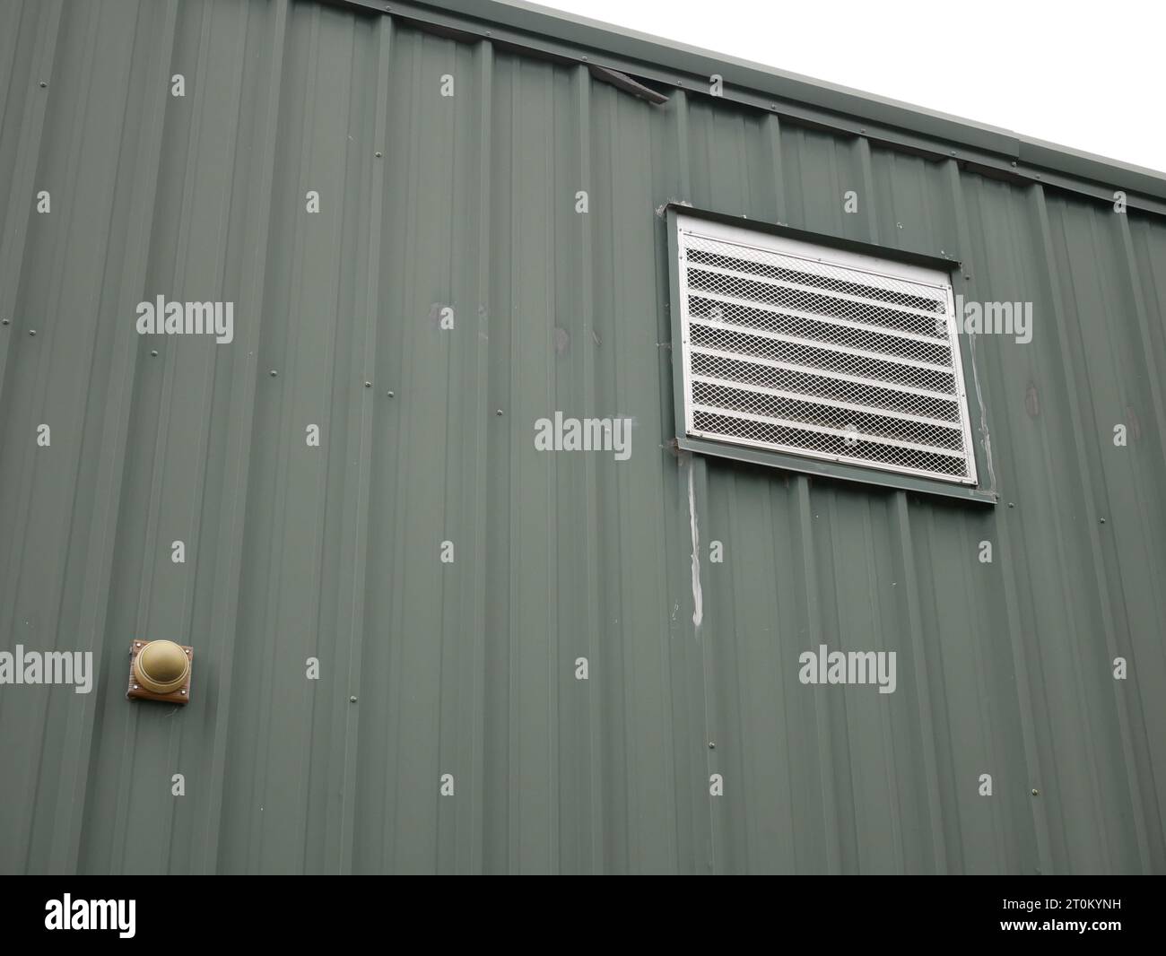 Green metal building with ventilation duct Stock Photo - Alamy