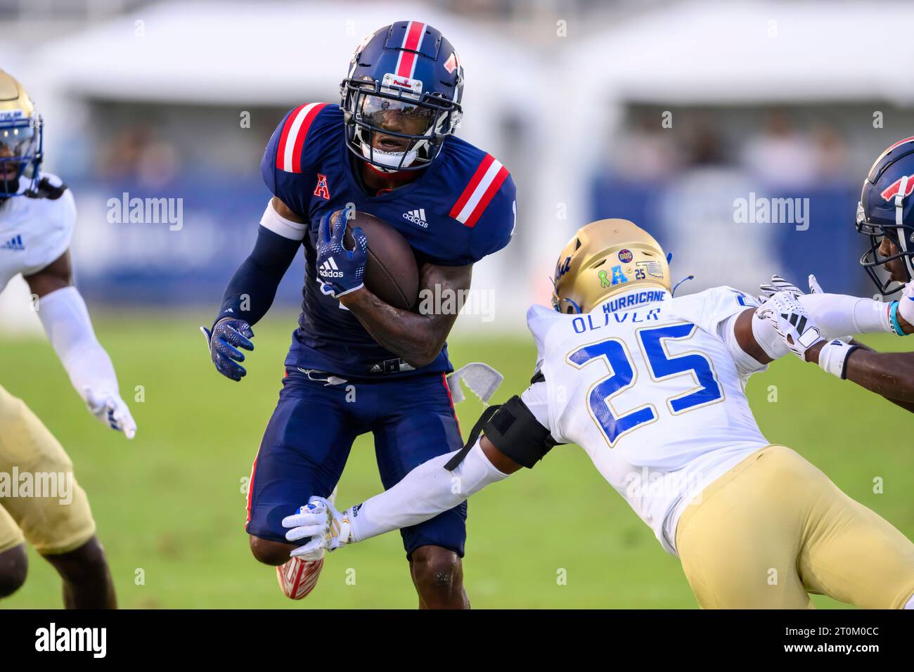 FAU wide receiver Lajohntay Wester (1) runs with ball and is tackled by ...