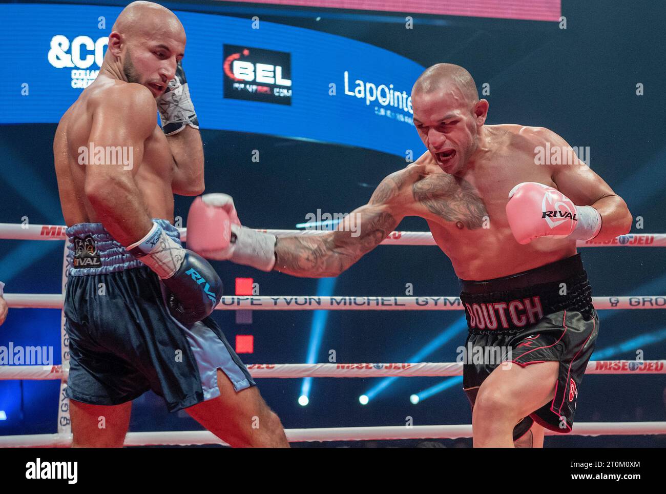 Sebastien Bouchard, right, and Mazlum Akdeniz, left, battle during a welterweight boxing match ...