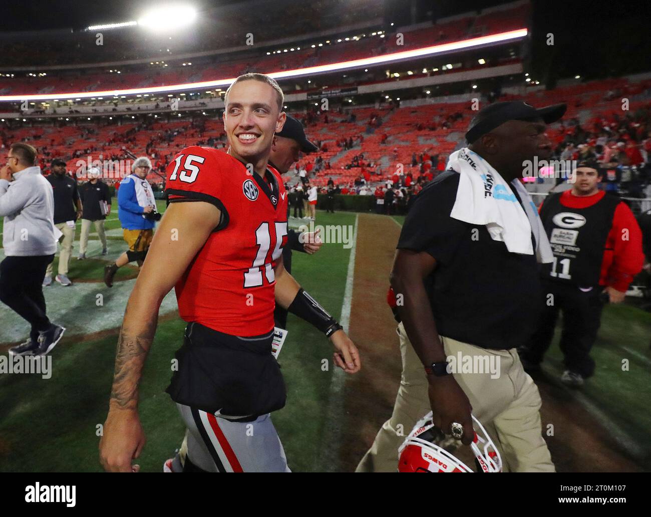Georgia quarterback Carson Beck smiles while walking off the field ...