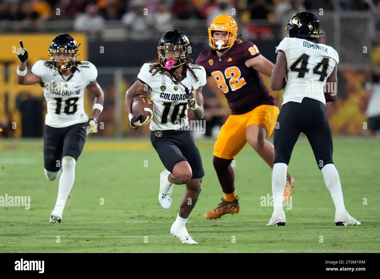 Colorado wide receiver Xavier Weaver (10) makes a long punt return as ...