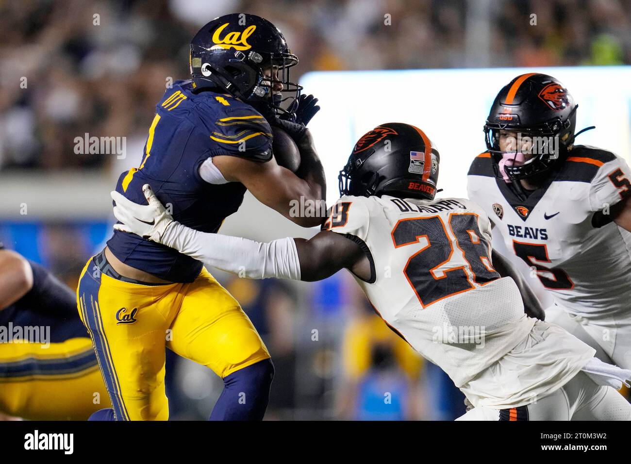 California running back Jaydn Ott, left, runs the ball against Oregon ...