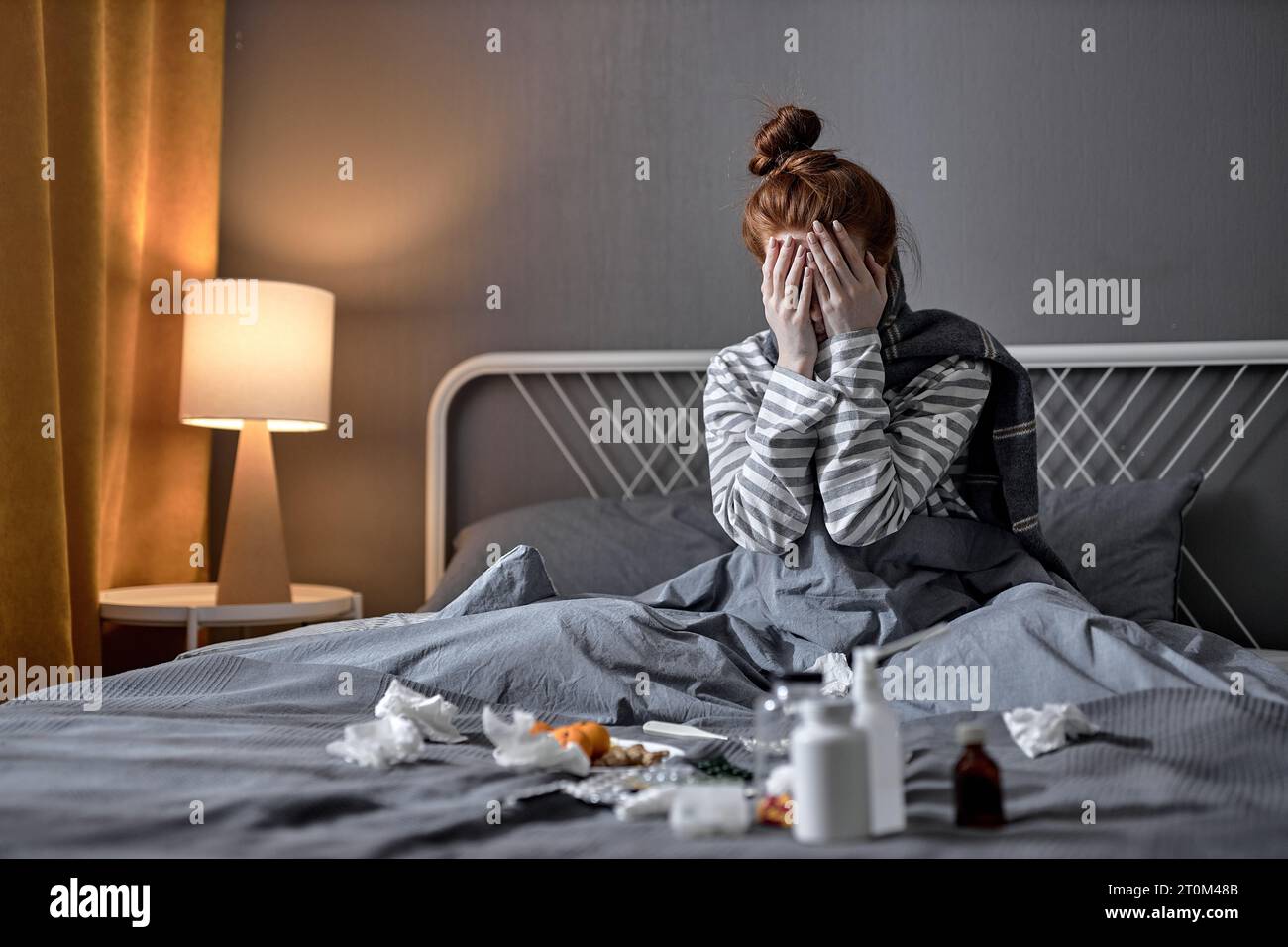 ginger girl closing her face with hands, palms, crying as she suffer ...