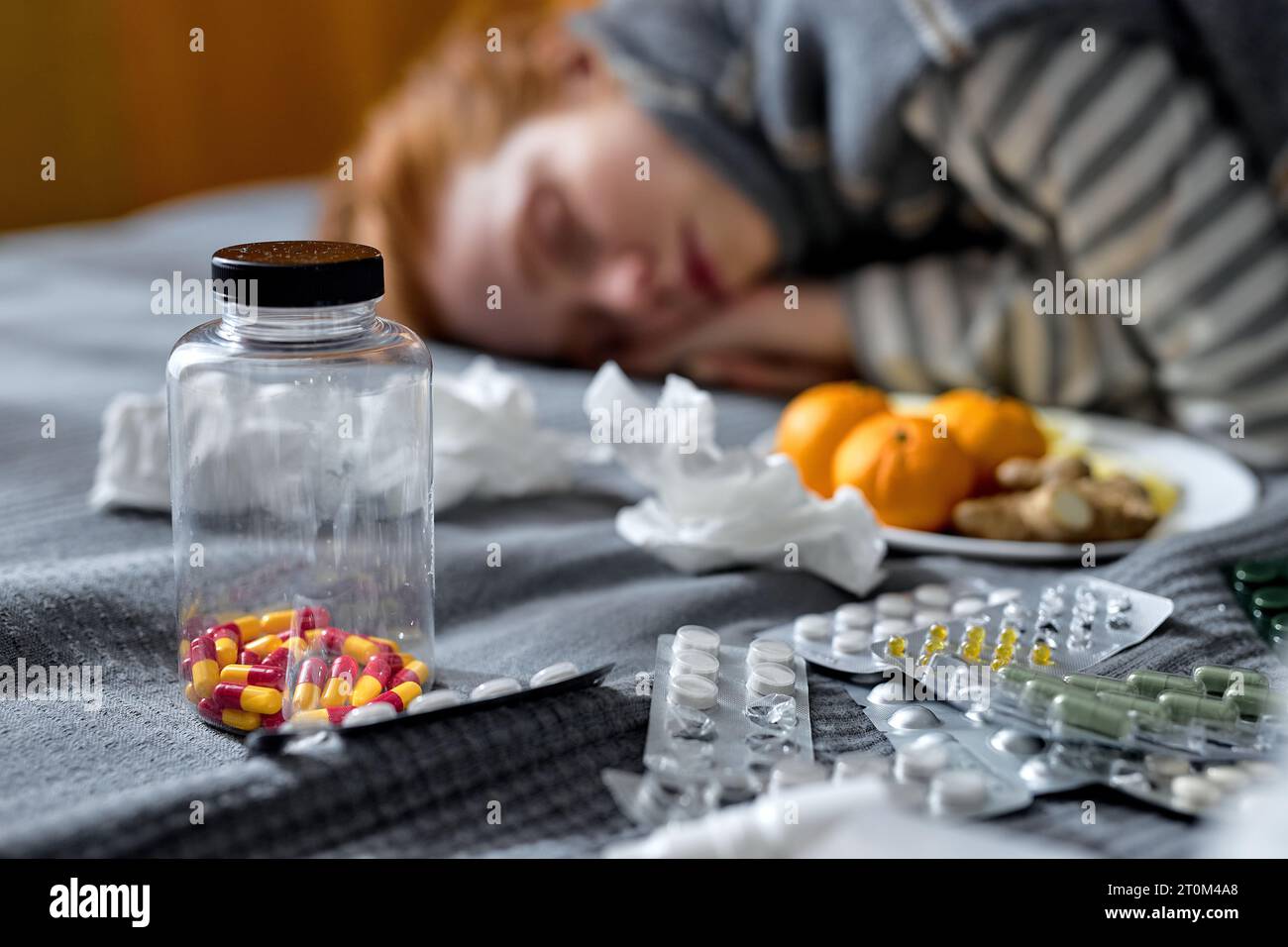 died ginger girl lying on bed, different drugs, pills in the foreground ...