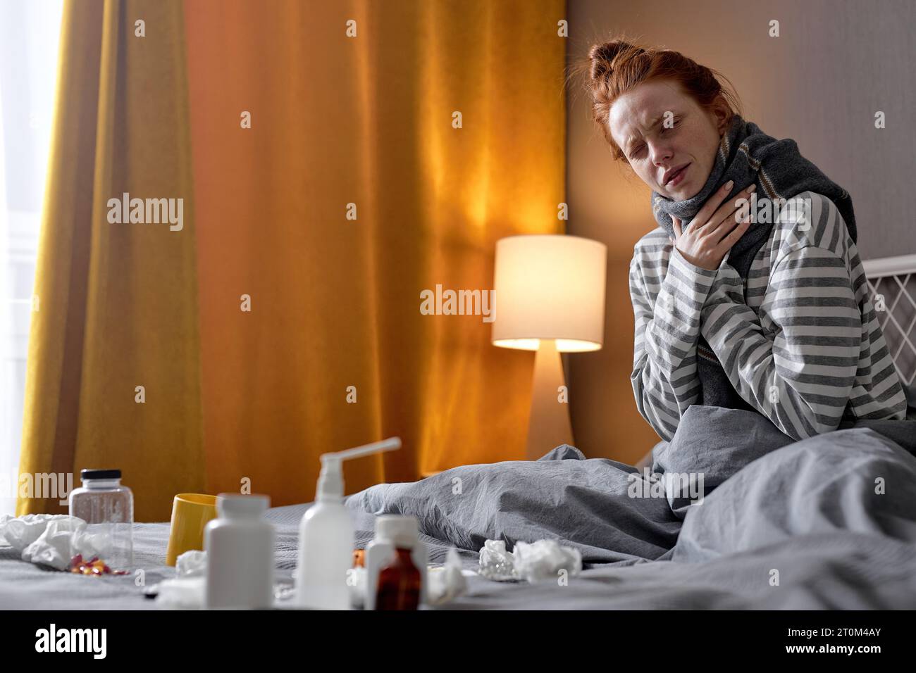 sad sick young Caucasian woman with sore throat at home health, cold ...
