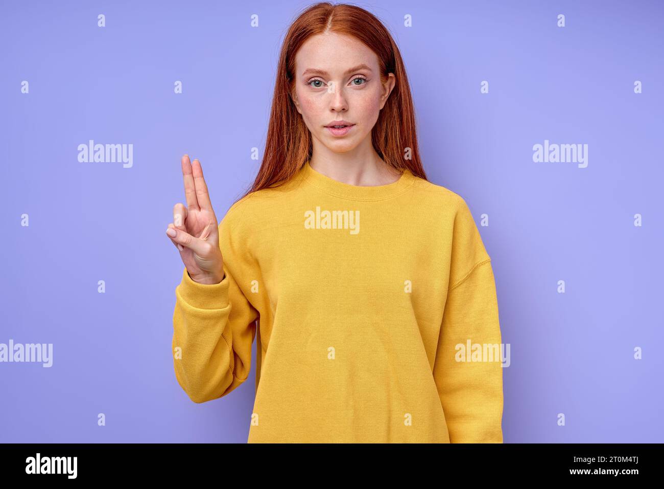 beautiful serious confident redhead woman in yellow stylish sweater ...