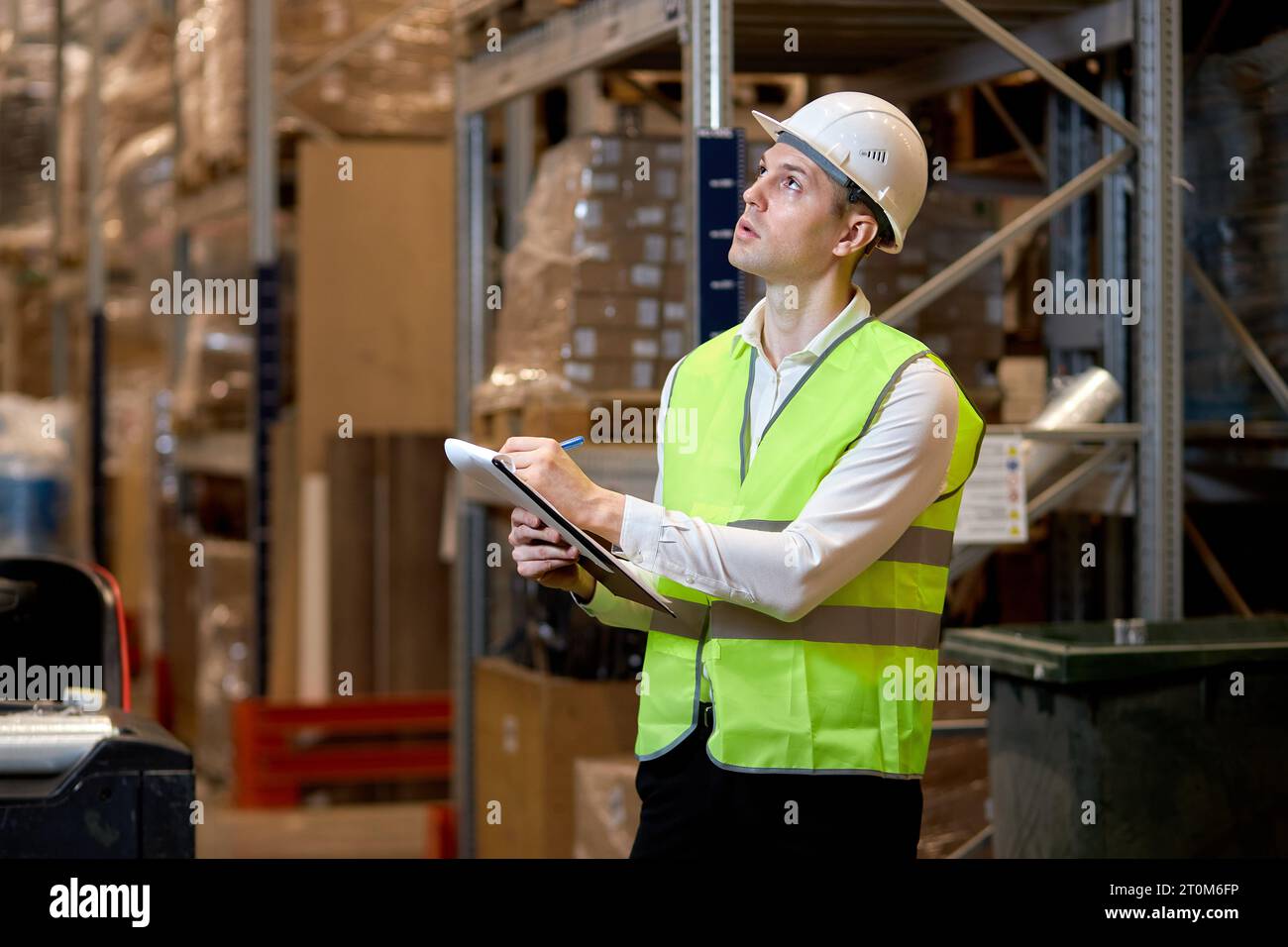 confident male worker doing stocktaking of product management on ...