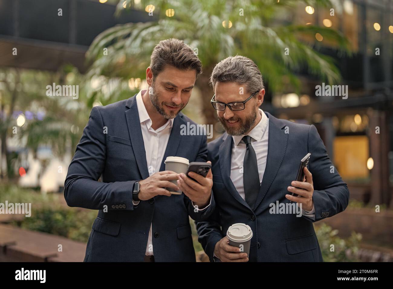 positive business men with phone in suit at coffee break. photo of ...