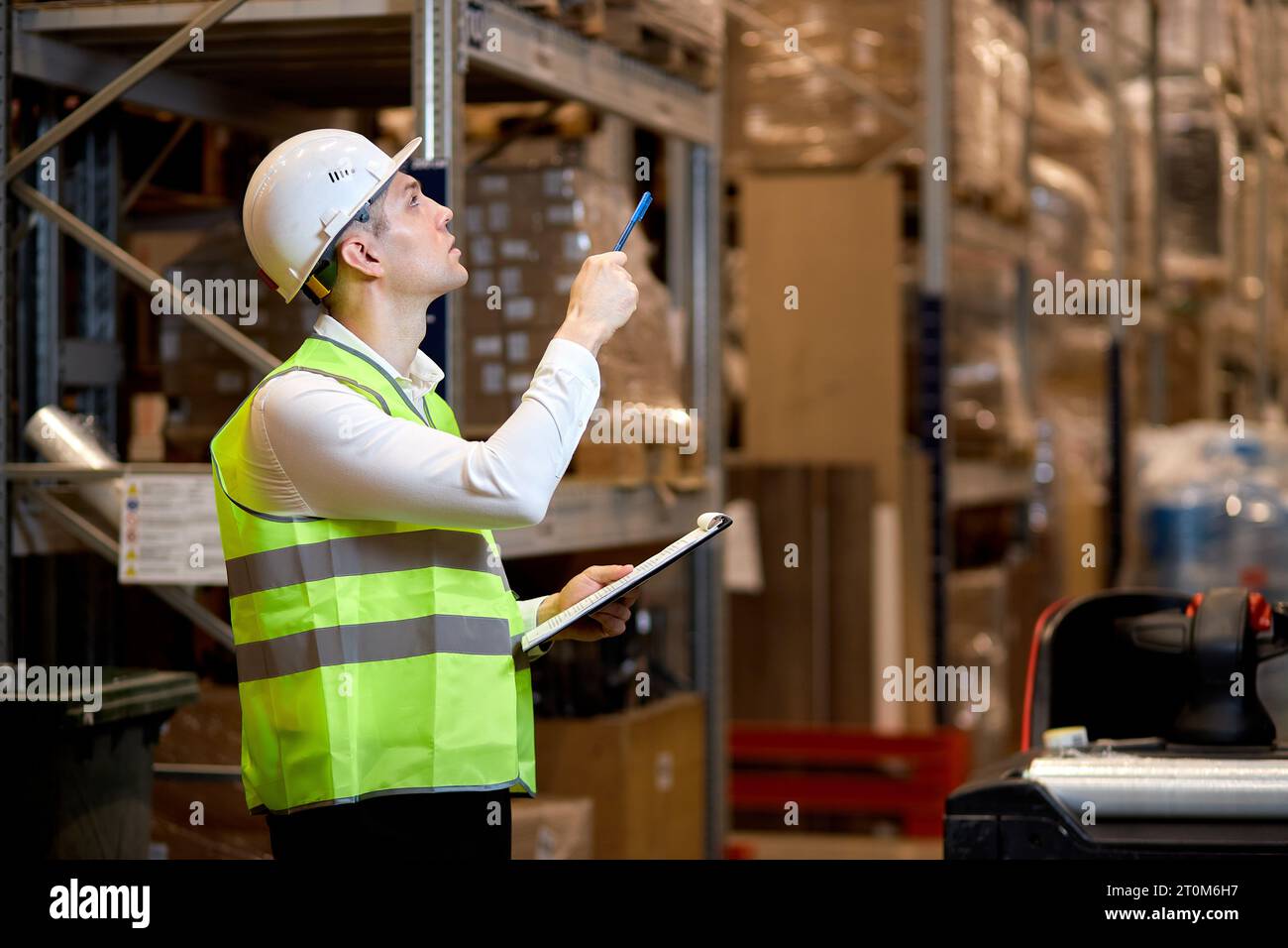 concentrated caucasian man worker in hard hat and working wear outfit ...