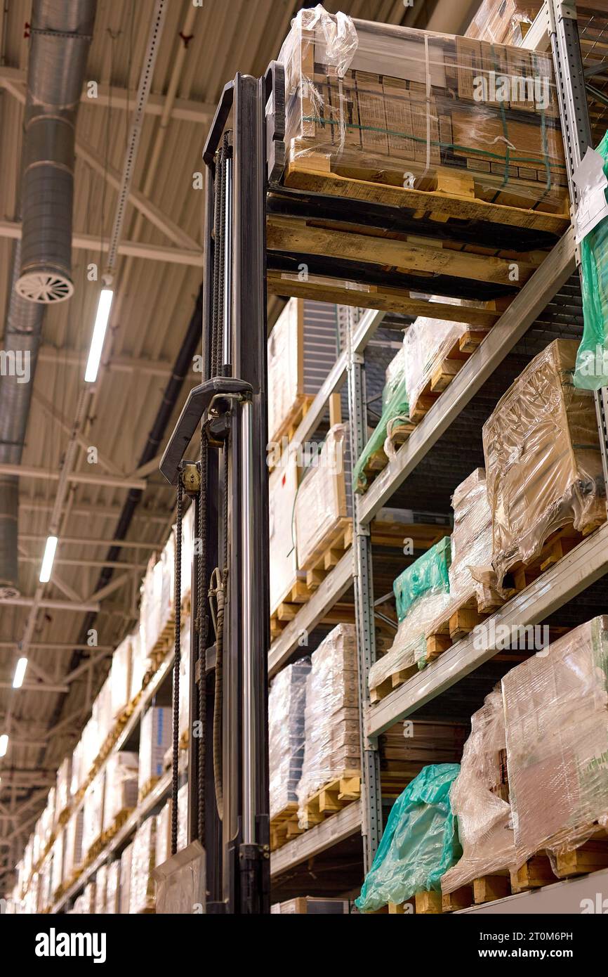 forklift loading shipment boxes goods on shelves in warehouse cargo ...