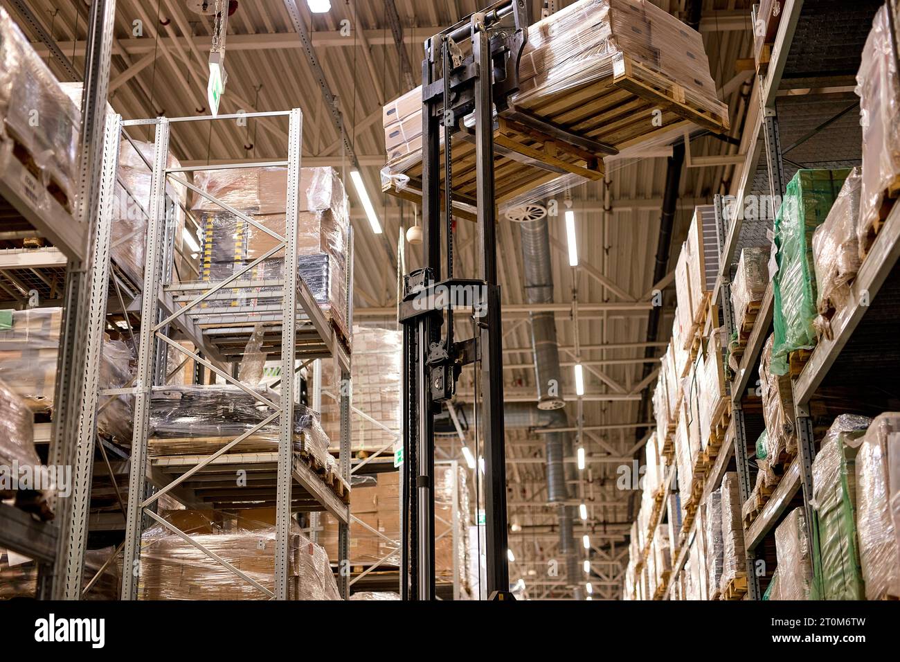 forklift loading shipment boxes goods on shelves in warehouse cargo ...