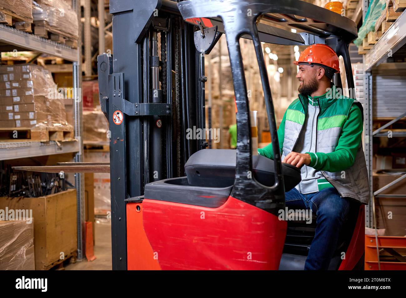 Retail Warehouse full of Shelves with Goods: man with Electric Forklift ...